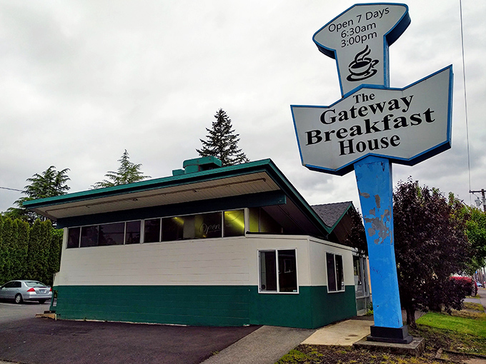 That tall blue sign acts like a breakfast beacon, guiding hungry souls to morning salvation.