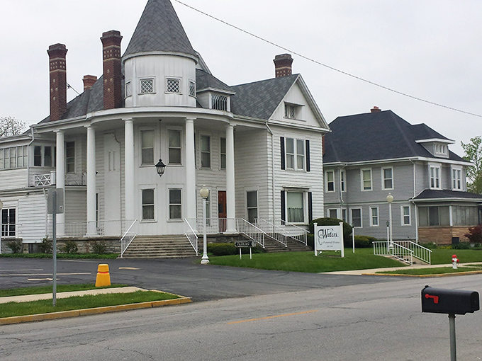 Take a stroll through Hartford City to admire this grand historic home, featuring a striking turret and classic wrap-around porch.