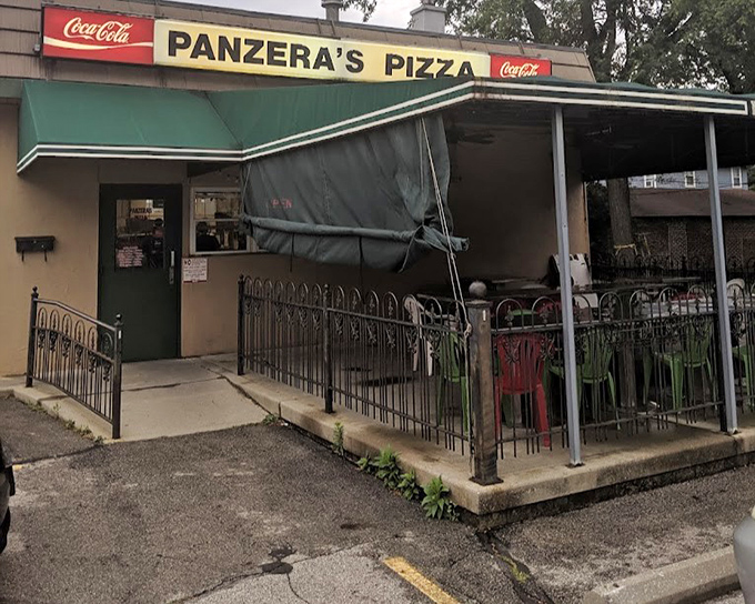 That cheerful red awning practically begs you to pull up a chair and stay awhile.