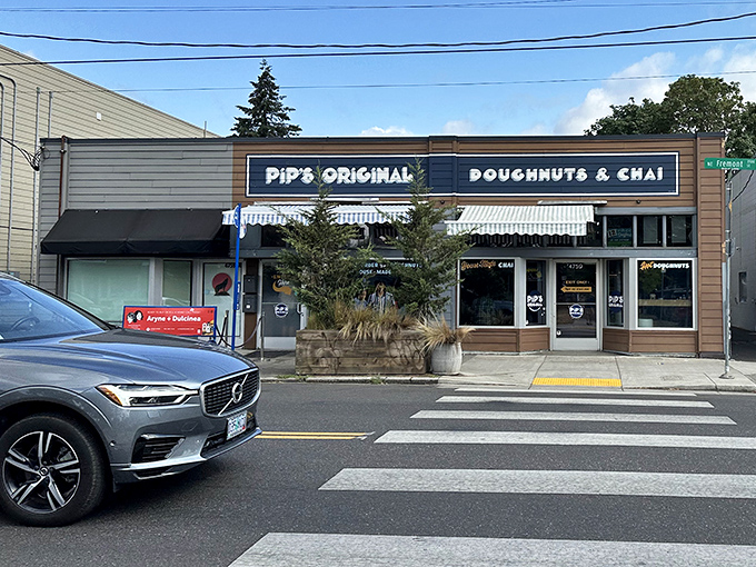 Pip's Original's charming storefront with its navy blue sign and wooden accents fits perfectly into Portland's Fremont neighborhood. The crosswalk leads right to donut heaven.