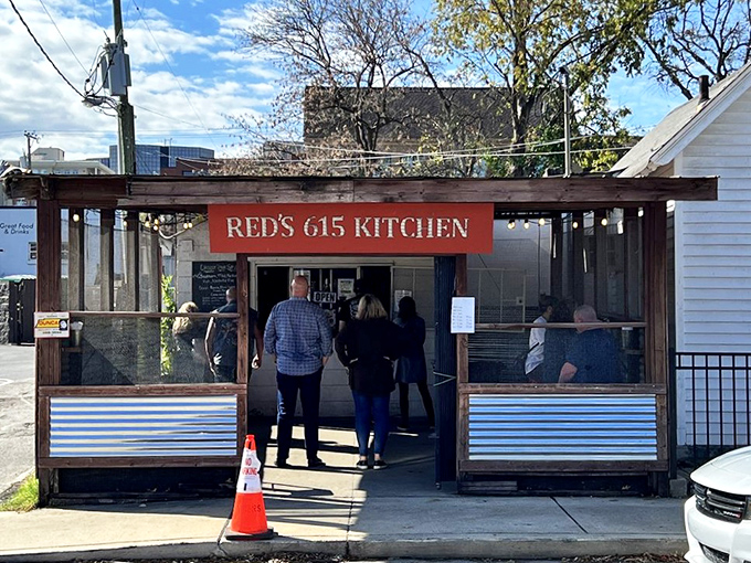 Red's food truck setup proves that great chicken doesn't need fancy digs, just passionate people and perfect spice.