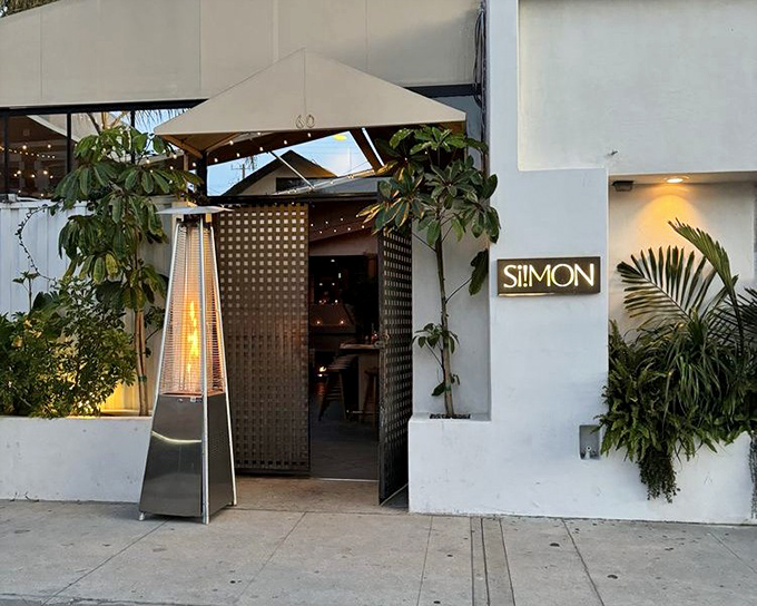 Si! Mon's sleek entrance hints at the modern seafood magic happening behind those minimalist white walls.