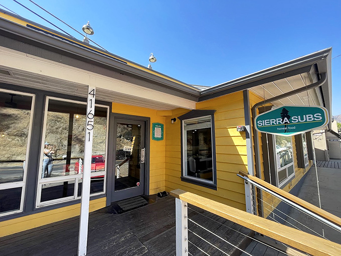 That golden yellow exterior practically glows against the mountain backdrop like a beacon of hope.