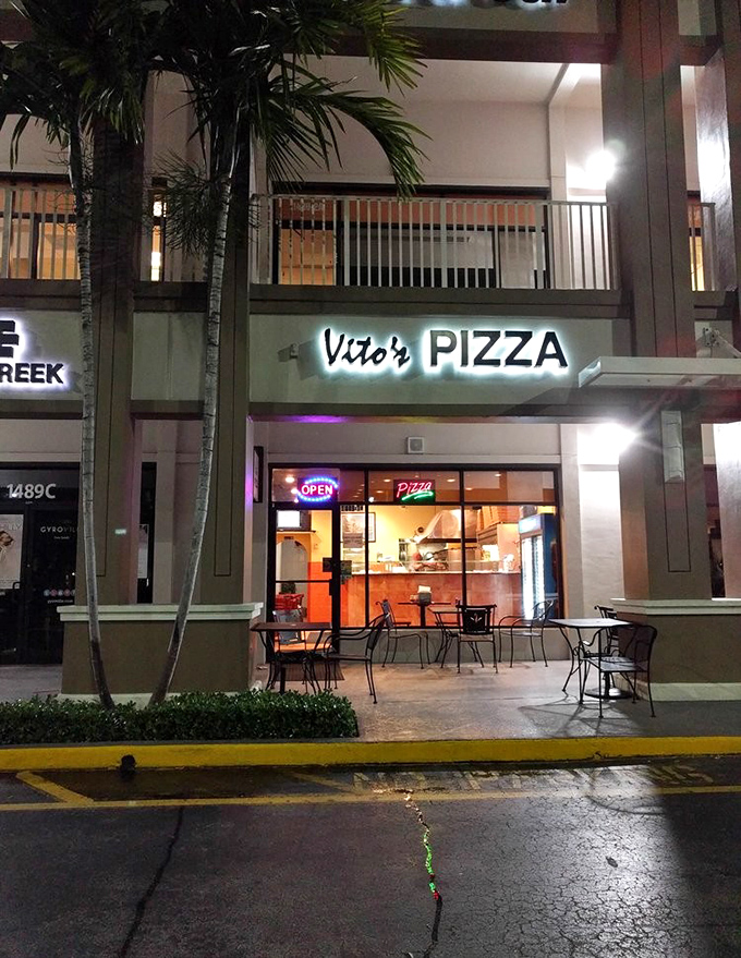 Vito's glowing storefront beckons pizza lovers seeking gourmet experiences in Fort Lauderdale's bustling dining landscape.