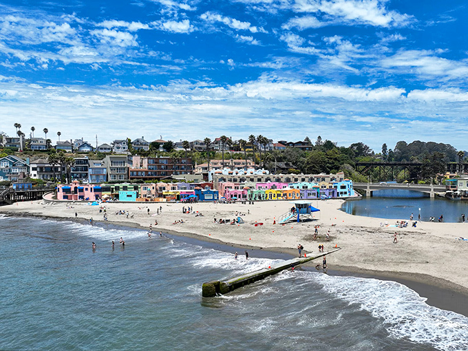 Colorful beach houses line this protected cove where gentle waves, artistic spirit, and bohemian charm create a photographer's dream destination.