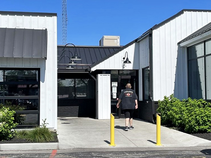 Sunlight bounces off the clean white exterior, promising seafood as fresh as the lake breeze. A hidden harbor for hungry travelers.