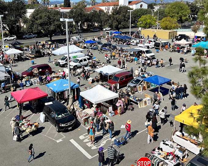 Bargain city from above! PCC's parking lot transforms into a patchwork quilt of canopies where treasure hunters navigate the maze like shopaholic detectives.