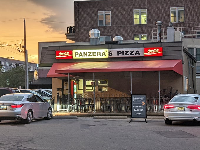 Sunset casts a golden glow on Panzera's inviting exterior. The red awning has sheltered generations of Grandview Heights pizza lovers.