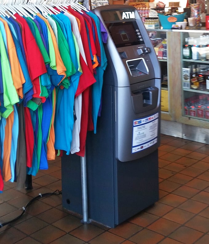 The ATM stands ready beside a rainbow of t-shirts &ndash; because in Key West, cash is king and colorful clothing is practically mandatory.