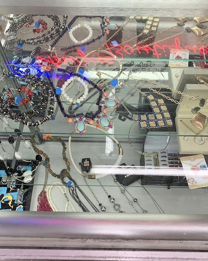 Jewelry display case glimmering with possibilities. Costume or genuine? The thrill of the unknown makes every necklace a potential jackpot.