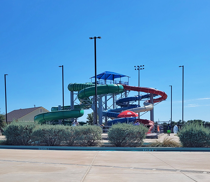 Adventure Cove's colorful water slides twist against the blue Texas sky, promising cool relief and squeals of delight during those scorching summer months.