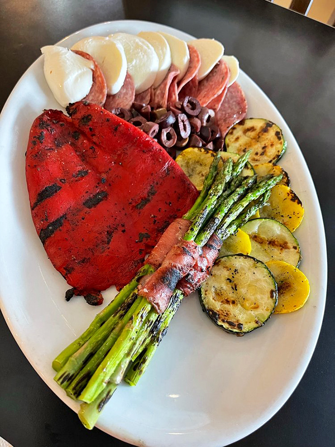 This antipasto platter isn't just appetizer&mdash;it's edible artwork featuring grilled vegetables, cured meats, and cheese that's traveled farther than most people's passports.