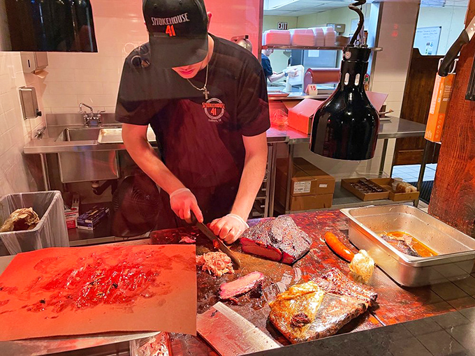 Where the magic happens &ndash; a pitmaster's hands transform humble cuts into transcendent barbecue through skill and patience.
