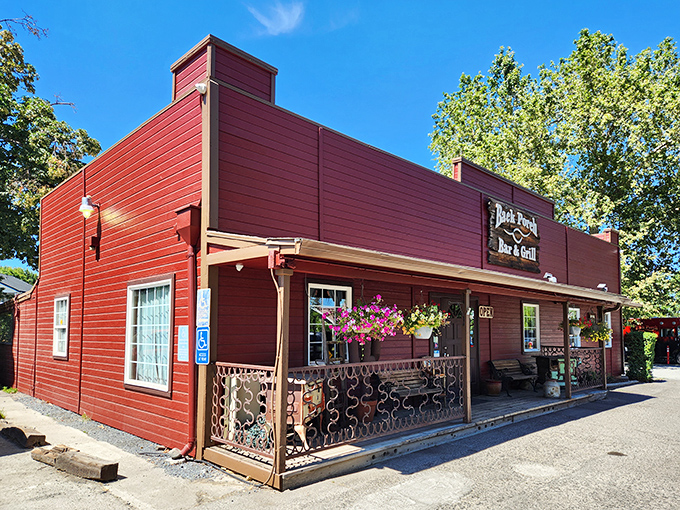 The Back Porch Bar & Grill's rustic red exterior promises exactly what its name suggests – comfort food served with a side of small-town charm.