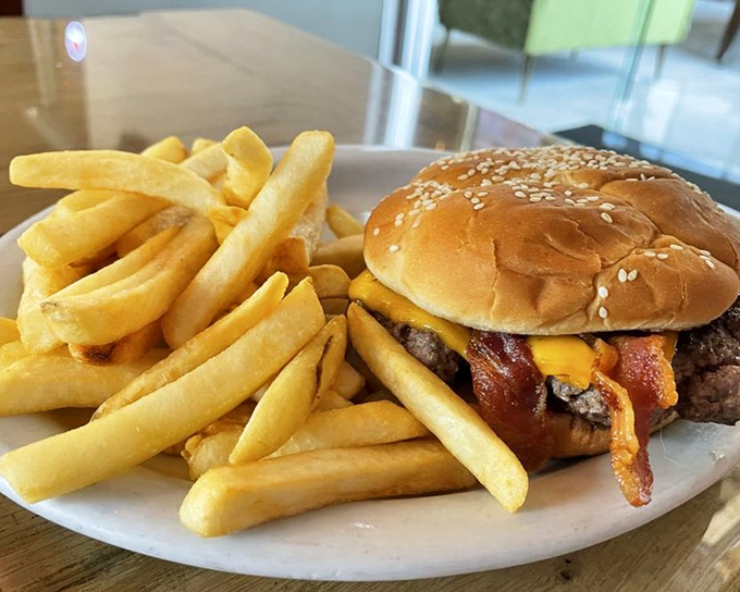 This isn't just a burger&mdash;it's a masterclass in American comfort food engineering. Melty cheese, crispy bacon, and fries that demand to be stolen.