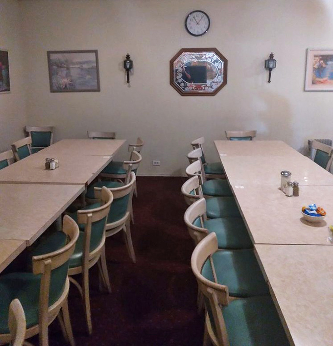 A separate dining area perfect for larger gatherings. Those mint-green chairs have supported generations of satisfied customers.