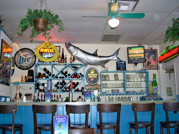 Behind the blue-paneled bar, local brews and maritime memorabilia create the quintessential Florida seafood joint atmosphere.