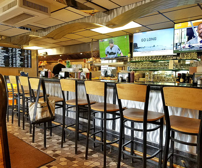 The bar area offers front-row seats to the culinary action, where sports on TV and pizza-making become equally captivating spectator sports.