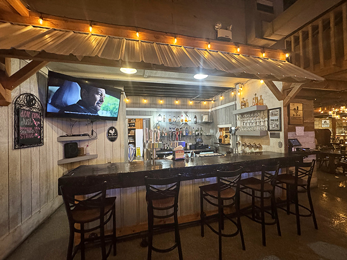 The bar area offers a cozy retreat where string lights cast a warm glow and conversations flow as freely as the beverages.