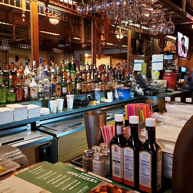 A bar stocked for serious business, where glasses hang like crystal stalactites waiting to be filled with liquid courage.