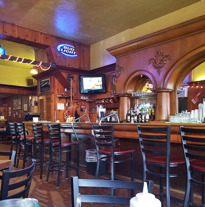 The bar area beckons with its warm wood tones and classic design&mdash;a place where strangers become friends over cold drinks and hot plates.