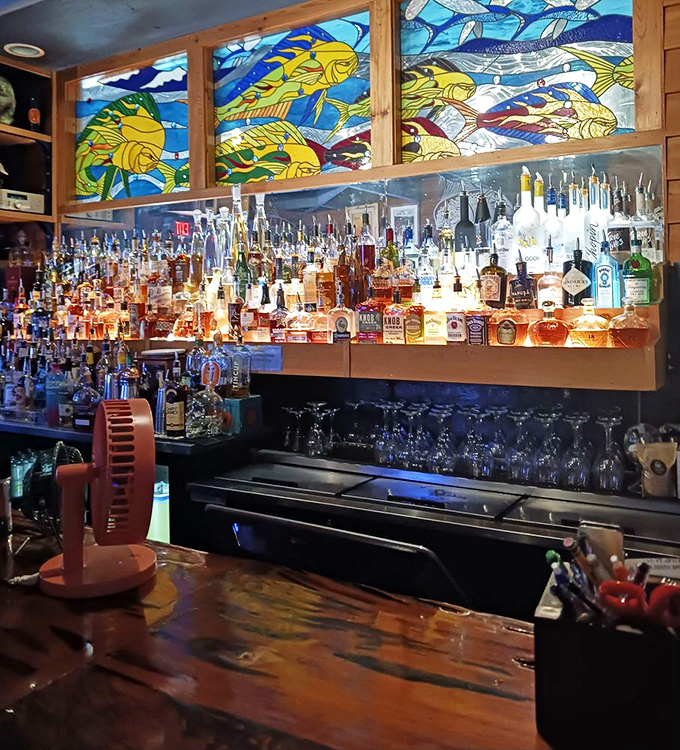 The bar's stained glass fish backdrop transforms ordinary cocktail hour into something magical&mdash;like drinking inside an aquatic kaleidoscope.