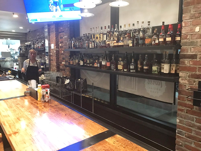 The bar's impressive whiskey collection isn't just for show. Each bottle stands ready to complement the smokehouse offerings like a faithful sidekick.