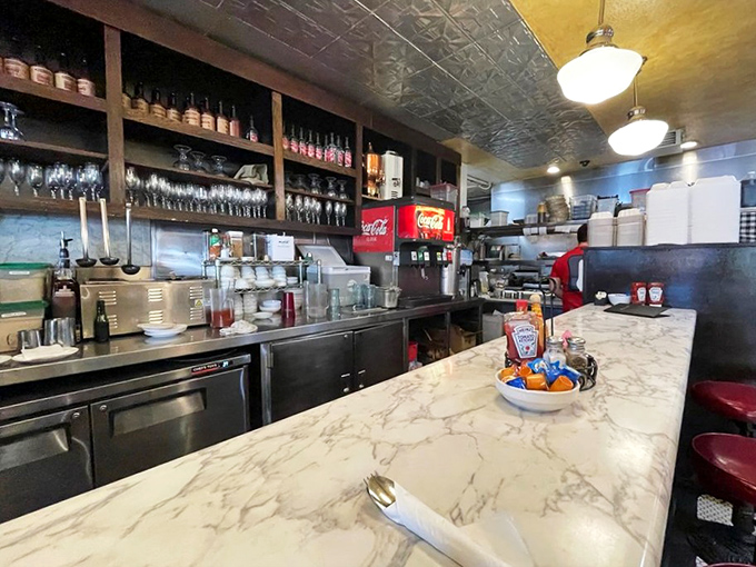 Behind the marble counter, the staff orchestrates breakfast magic with the efficiency of a symphony and warmth of old friends.