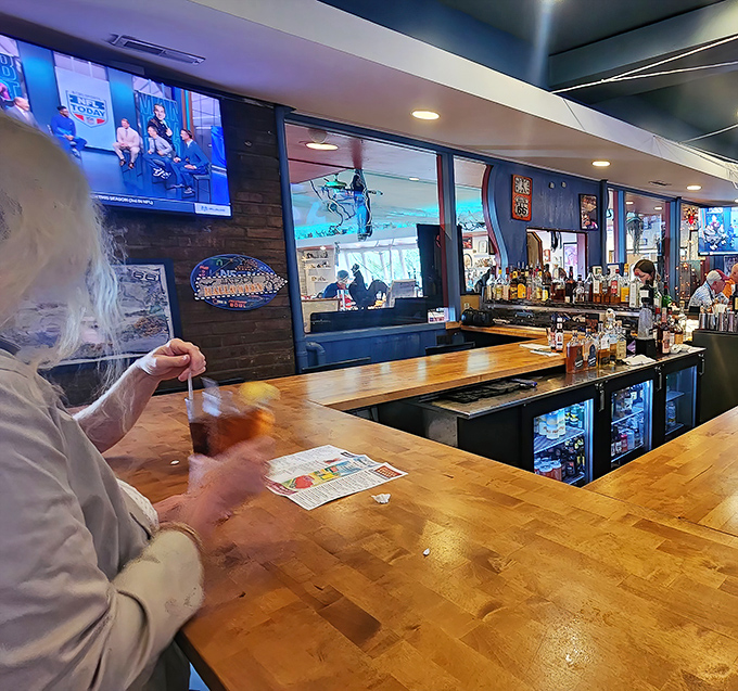 Not just a bar &ndash; it's command central for liquid refreshment. The wooden bartop has supported countless elbows and chicken-induced happiness.