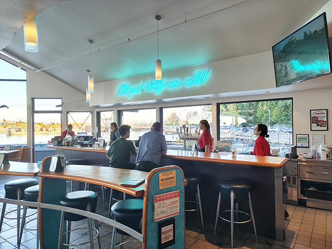 "Good things are wild" indeed—especially when "wild" refers to the fresh-caught seafood being prepared behind that bar. The blue lighting adds underwater magic.