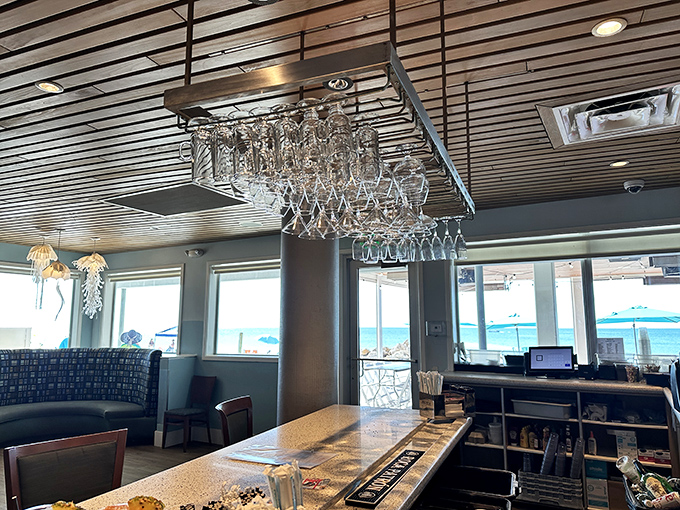 The hanging glassware catches light like crystal chandeliers, turning this bar into the stage for your next great vacation story.