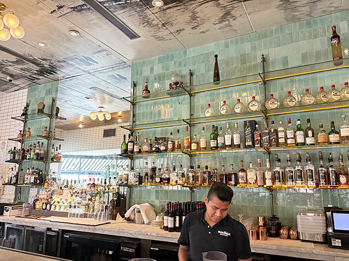 AMBAR's bar showcases an impressive collection of rakija and spirits. Those aqua tiles create the perfect backdrop for liquid courage before trying beef tartare.