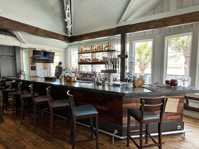 The bar area: where wood, light, and liquor come together in a trinity of relaxation that whispers, "Stay awhile, the ocean isn't going anywhere."
