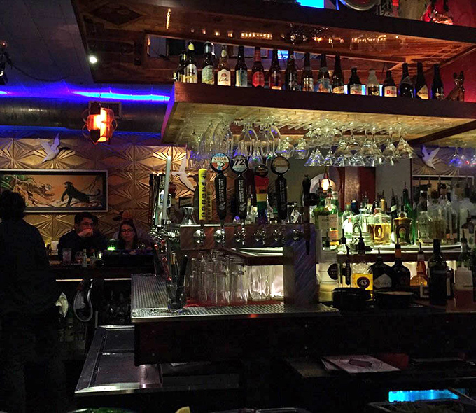 The bar glows with possibility, bottles backlit like trophies and taps standing ready for thirsty patrons seeking liquid refreshment.