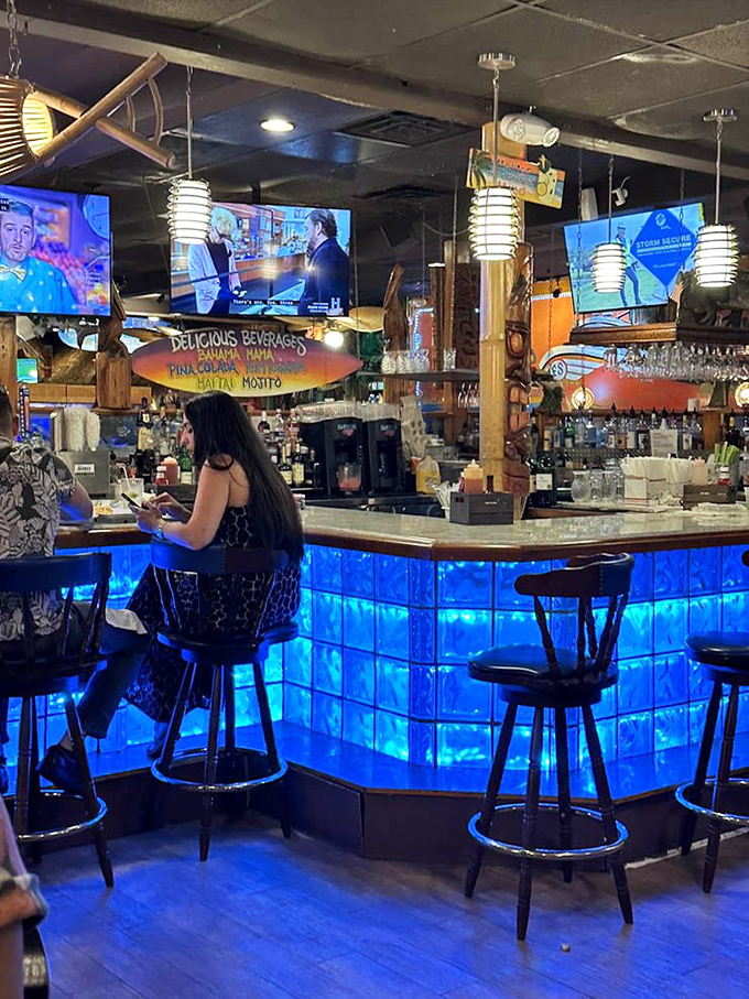 A bar that glows blue like the bioluminescent waters of Florida's coast. The drinks flow as freely as the conversation.