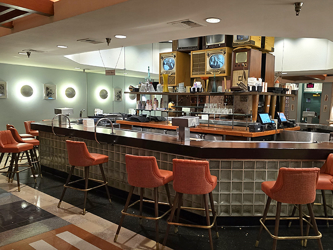 The bar area looks like it was plucked from an episode of "I Love Lucy." Those coral-colored stools have heard more gossip than a beauty parlor.
