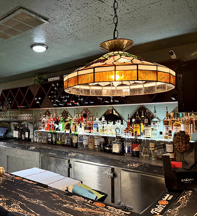 The bar's Tiffany-style lamp casts a warm glow over decades of spirits &ndash; some bottles might be newer than others, but the hospitality is consistently vintage.