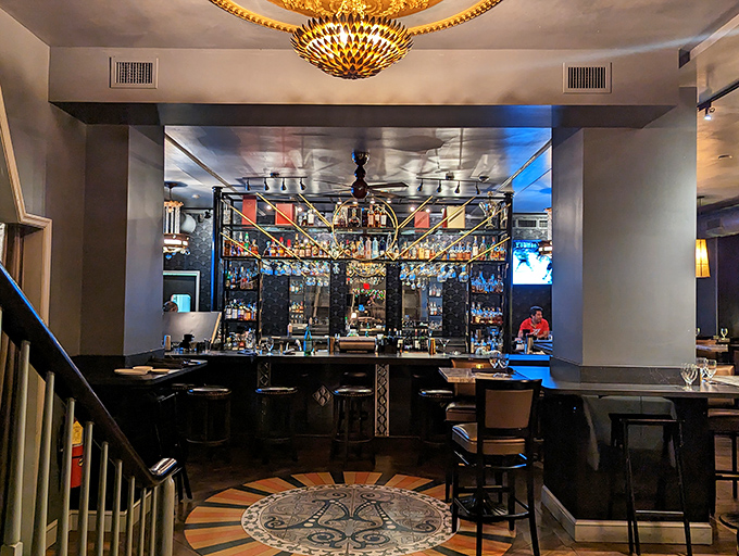 The bar gleams with promise and possibility, each bottle a story waiting to be poured. That mosaic floor has seen some decisions made.