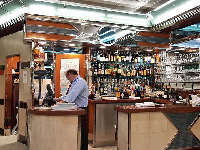 The bar area &ndash; where evening conversations flow as smoothly as the drinks, under the watchful gaze of bottles lined up like old friends.