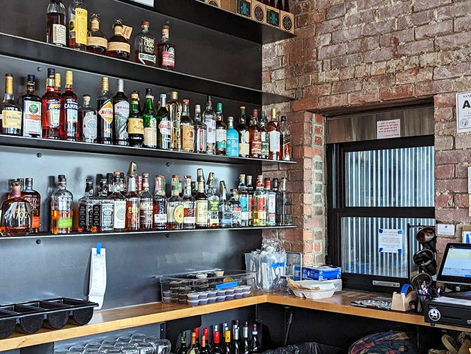 The bar shelves tell a story of thoughtful curation &ndash; a liquid library where bourbon and craft spirits stand ready to complement smoky flavors.