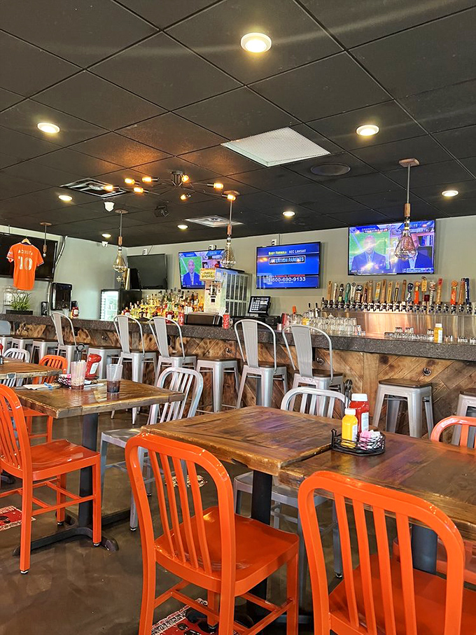 The bar area combines industrial chic with sports bar comfort, where craft beers flow and burger decisions are contemplated.