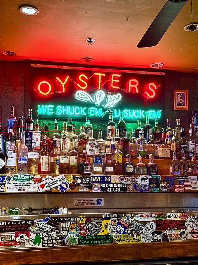 The neon "We shuck 'em, you suck 'em" sign perfectly captures the unpretentious attitude that makes this place a true Atlanta gem.