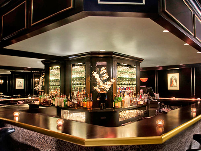 The bar gleams with promise and possibility. This liquid library, stocked with every spirit imaginable, is where classic cocktails are crafted with reverence and precision.