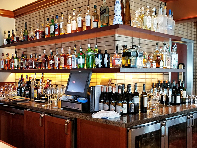 The bar shelves glow with amber promise &ndash; a well-stocked lighthouse guiding you safely through your seafood journey with liquid reinforcements.