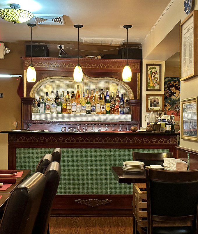 The bar area combines old-world charm with modern comfort. Those pendant lights cast the kind of glow that makes everyone look like they're in a movie.