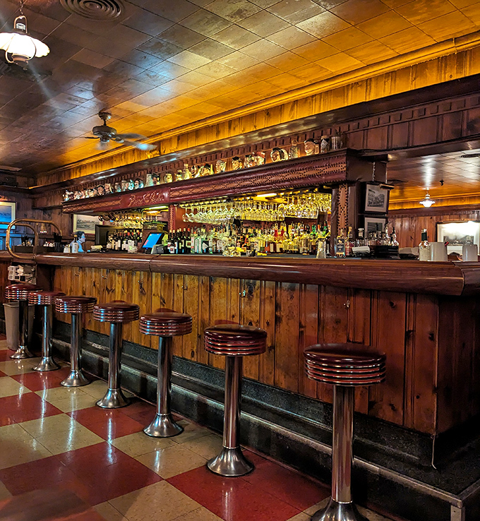 The bar gleams with bottles and possibility, a testament to the art of hospitality where bartenders still remember what you drink.
