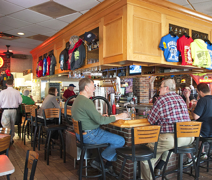 The bar area—where strangers become friends and friends become family. Notice the Hodak's merchandise—proof people want to take this experience home.