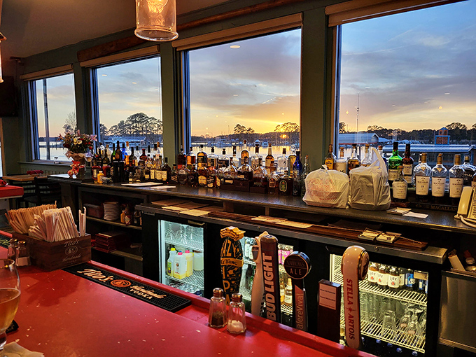 A bar with a view that makes even non-drinkers consider ordering a double. As the sun sets, the bottles glow like an amber-hued promise.