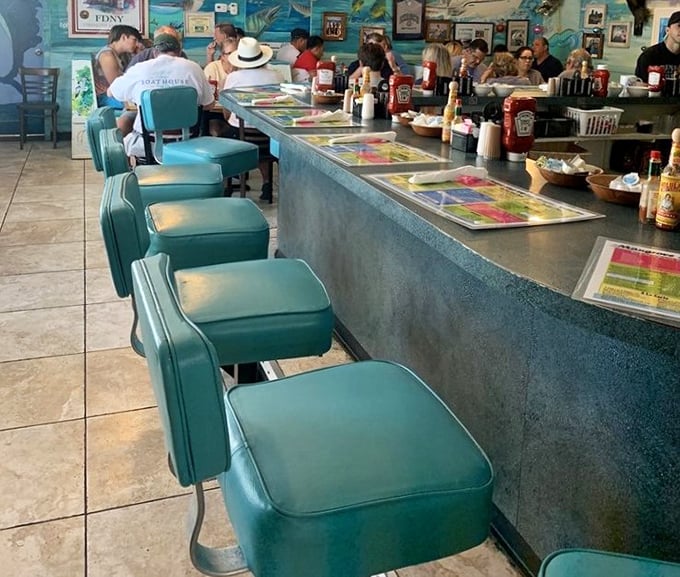 Classic diner counter seating in that signature turquoise. Where solo diners become temporary locals and coffee refills flow like the tide.