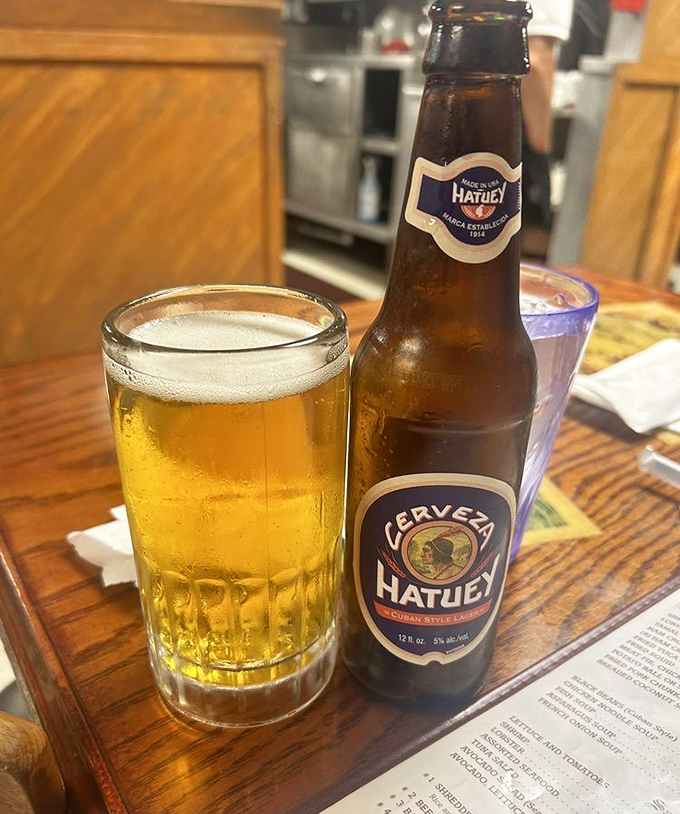 A cold Hatuey beer, the perfect companion for any Cuban feast&mdash;like finding an old friend at the table.